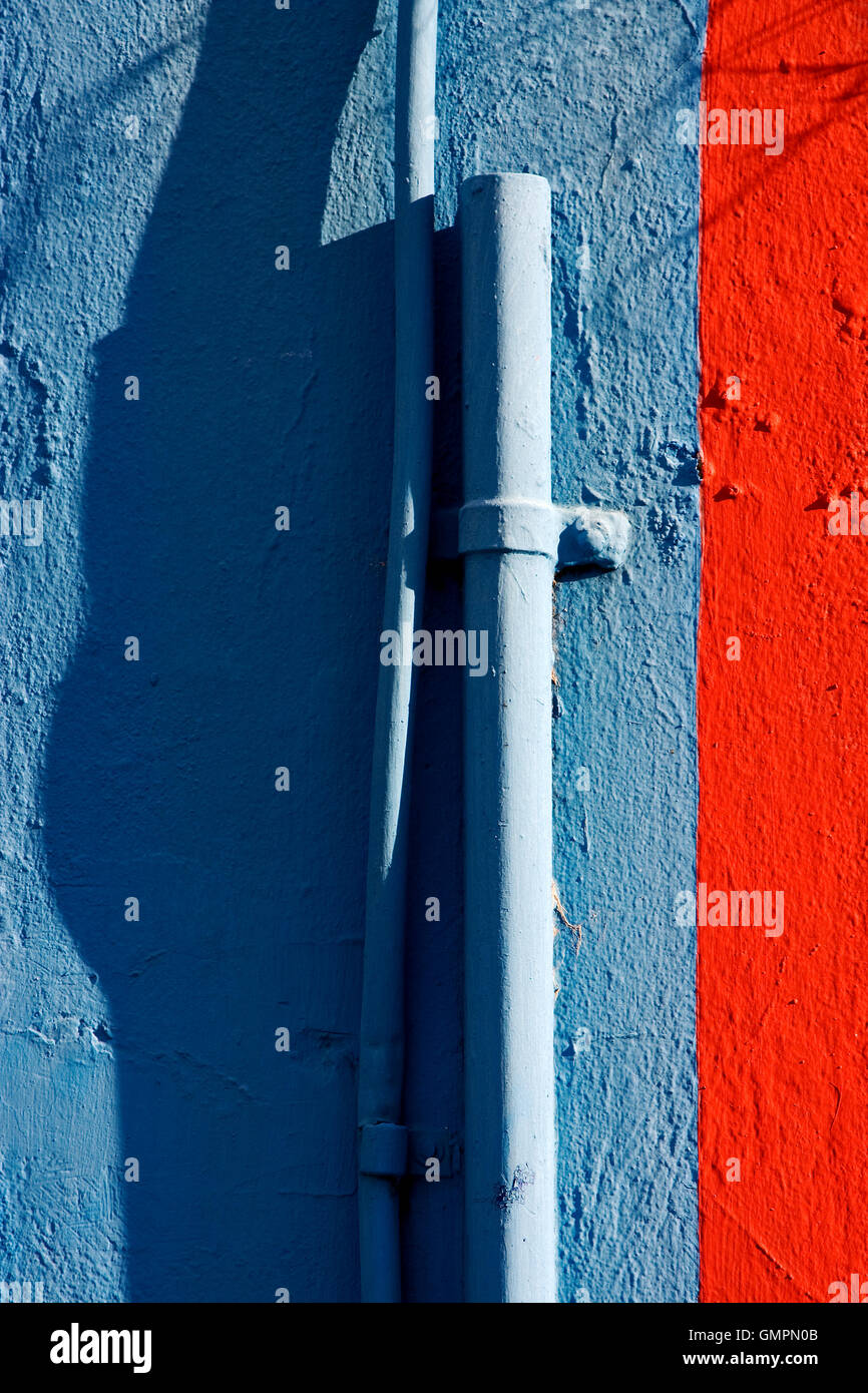 blue colored pipe and red wall Stock Photo - Alamy