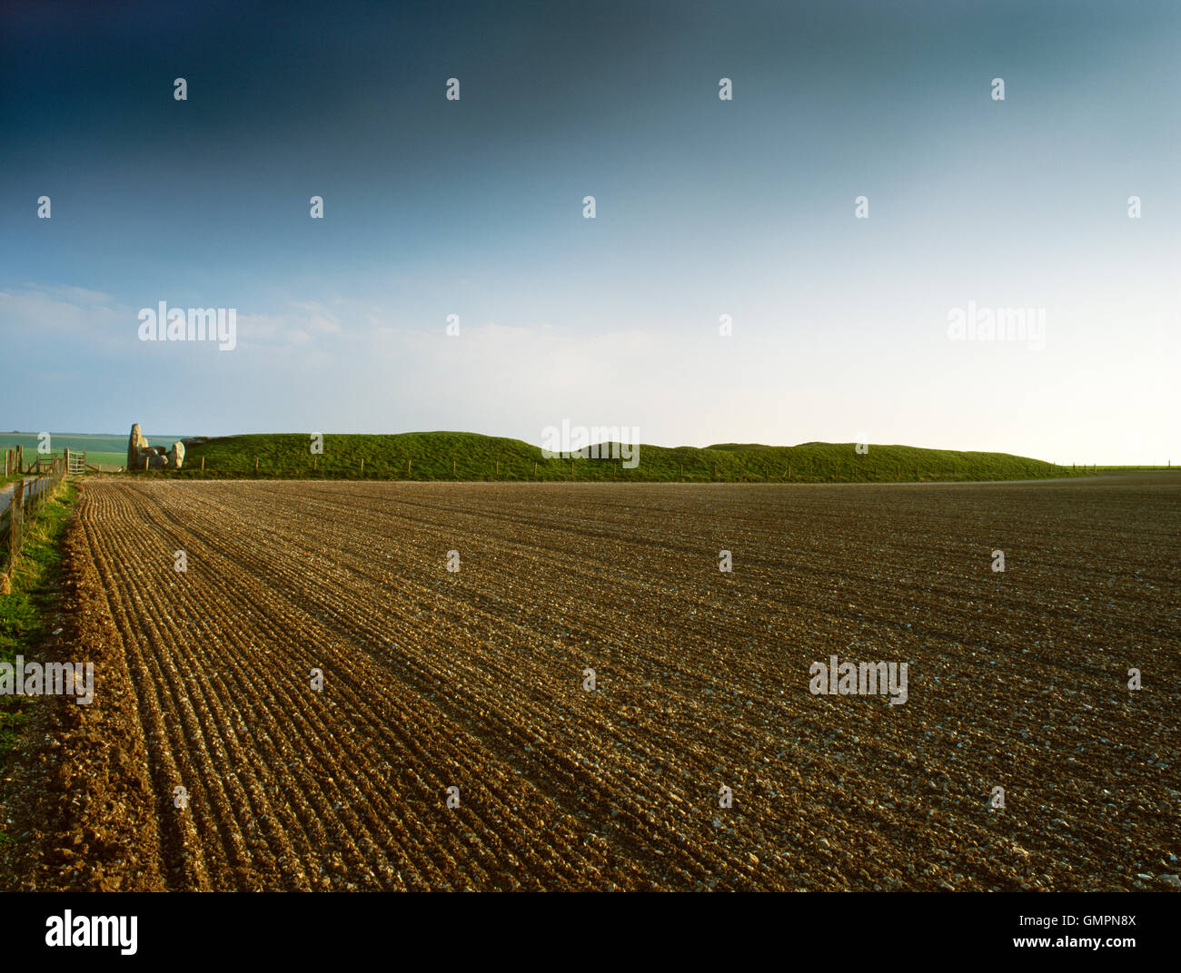 A profile view of the stone entrance facade (L) & earthen long mound of ...