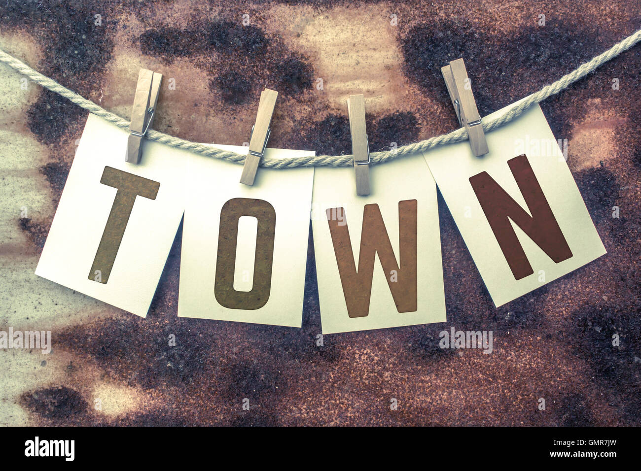 The word "TOWN" stamped on cards and pinned to an old piece of twine ...
