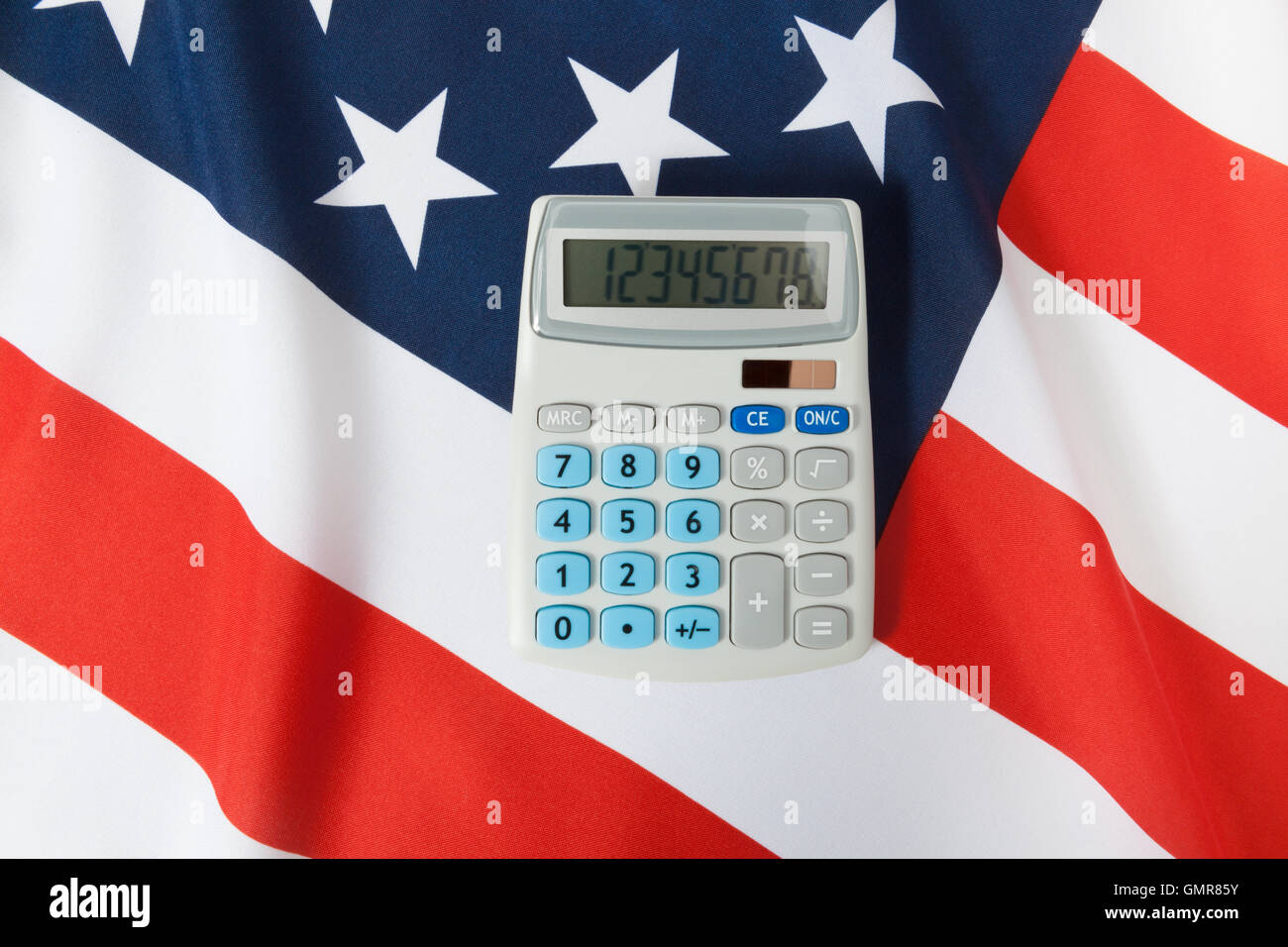 Part of studio shoot ruffled national flag with calculator over it ...
