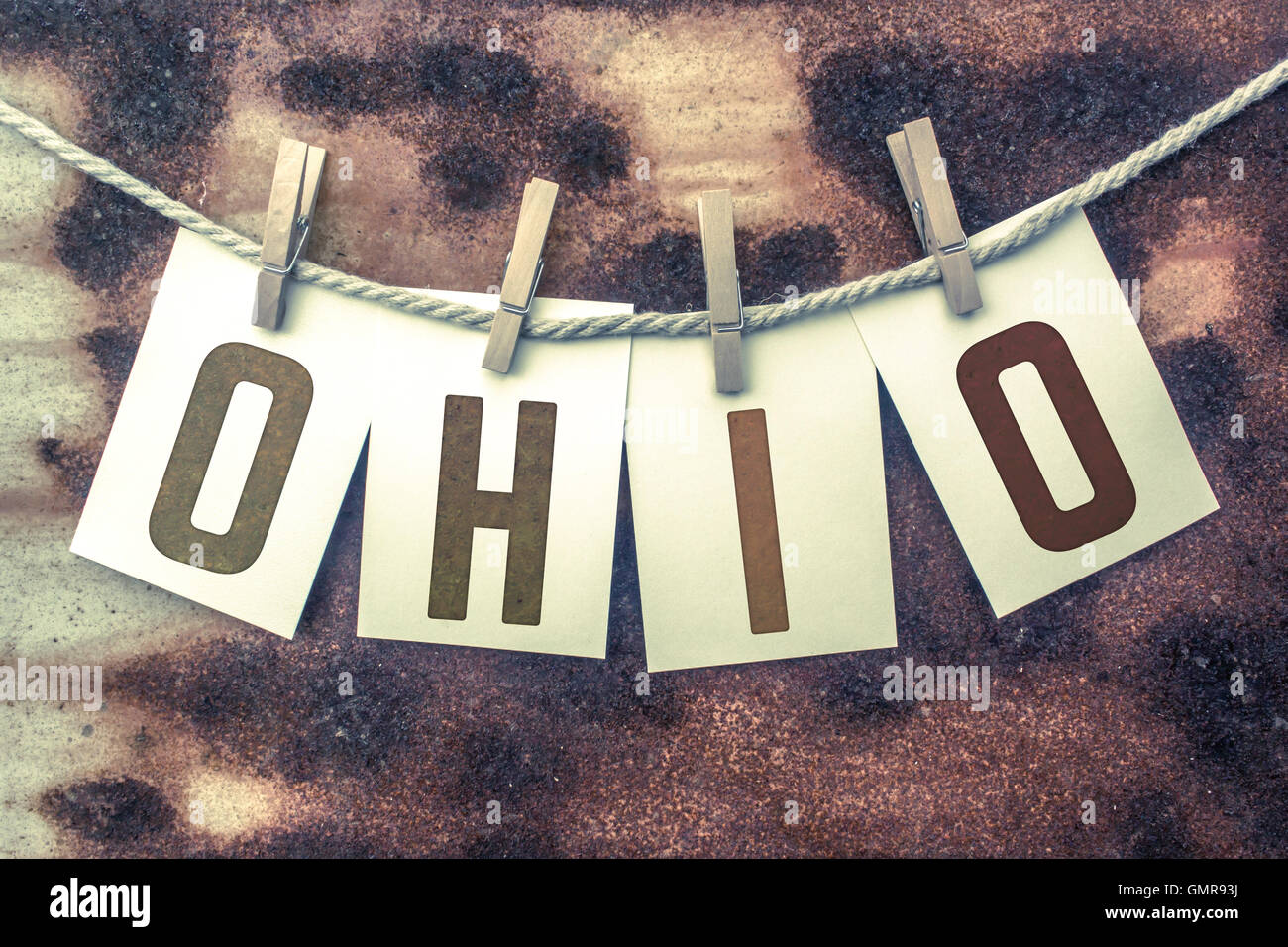 The word "OHIO" stamped on cards and pinned to an old piece of twine ...