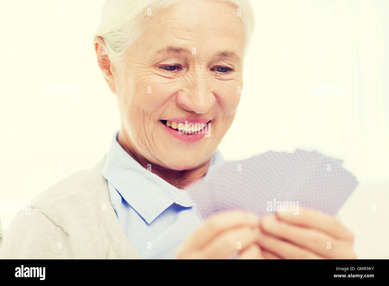 happy senior woman playing cards at home Stock Photo - Alamy