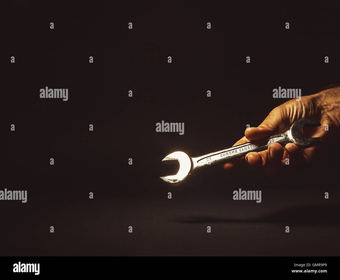 Conceptual composition, man's hand holding a key tool, number 22, made ...