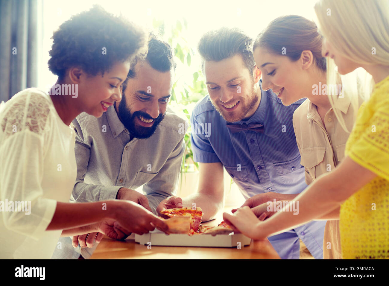 happy business team eating pizza in office Stock Photo - Alamy