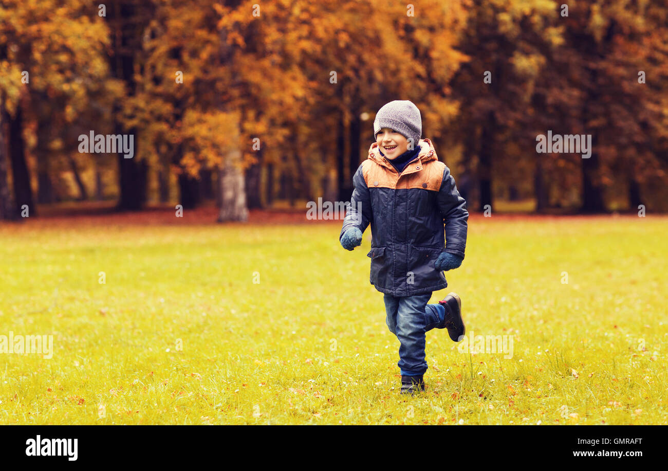 happy little boy running on autumn park field Stock Photo - Alamy