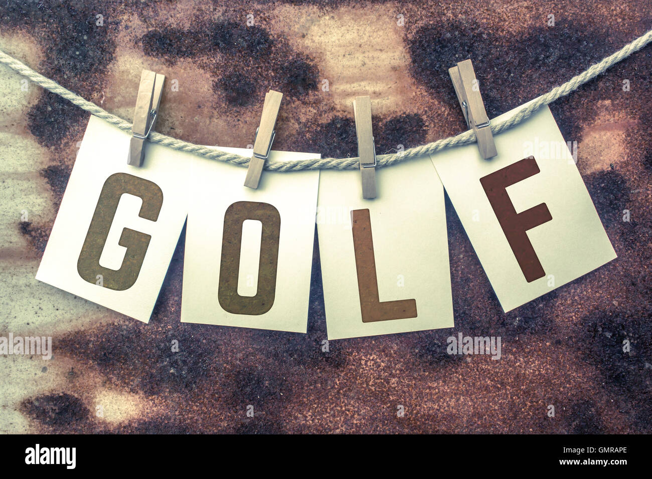 The word "GOLF" stamped on cards and pinned to an old piece of twine ...