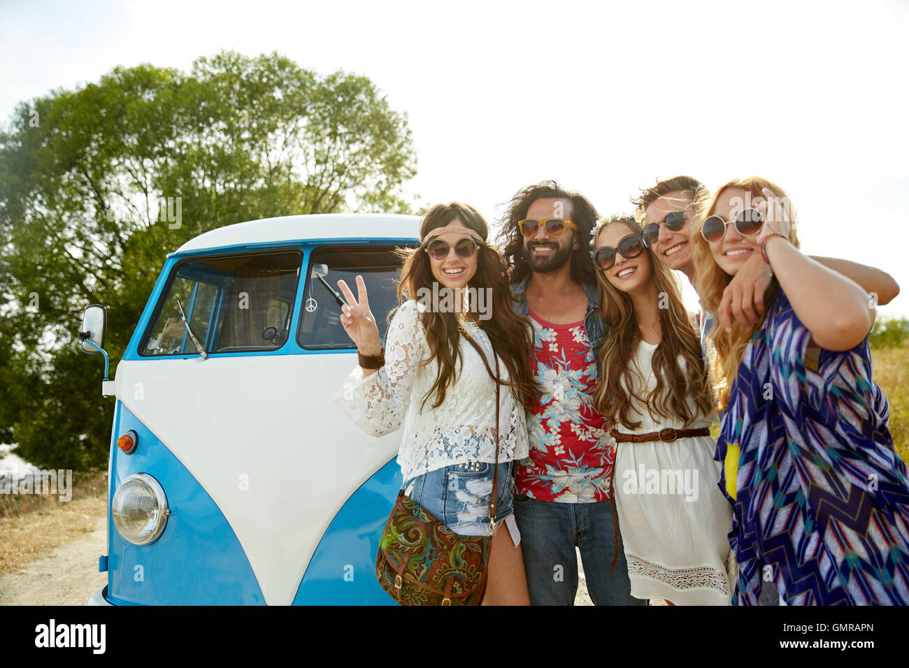 hippie friends over minivan car showing peace sign Stock Photo - Alamy