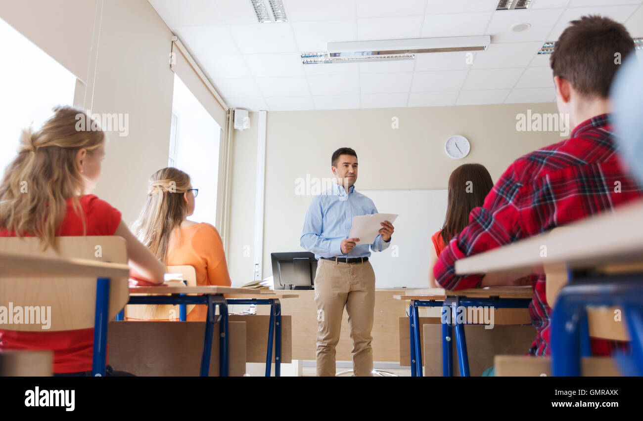 group of students and teacher with papers or tests Stock Photo - Alamy