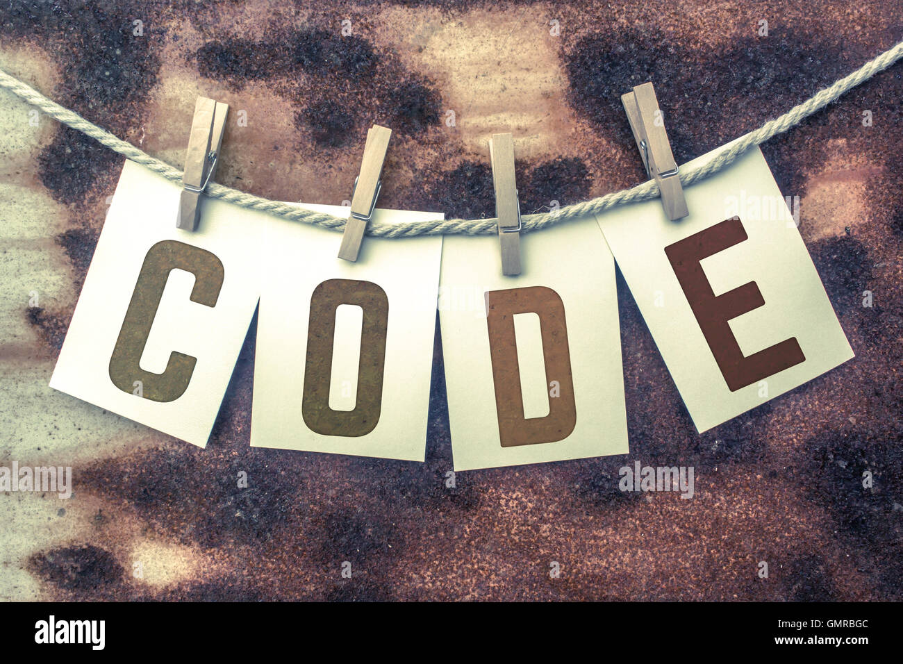 The word "CODE" stamped on cards and pinned to an old piece of twine ...
