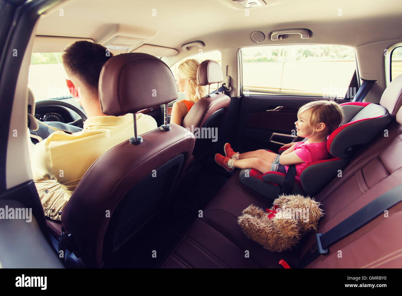 happy parents with little child driving in car Stock Photo - Alamy