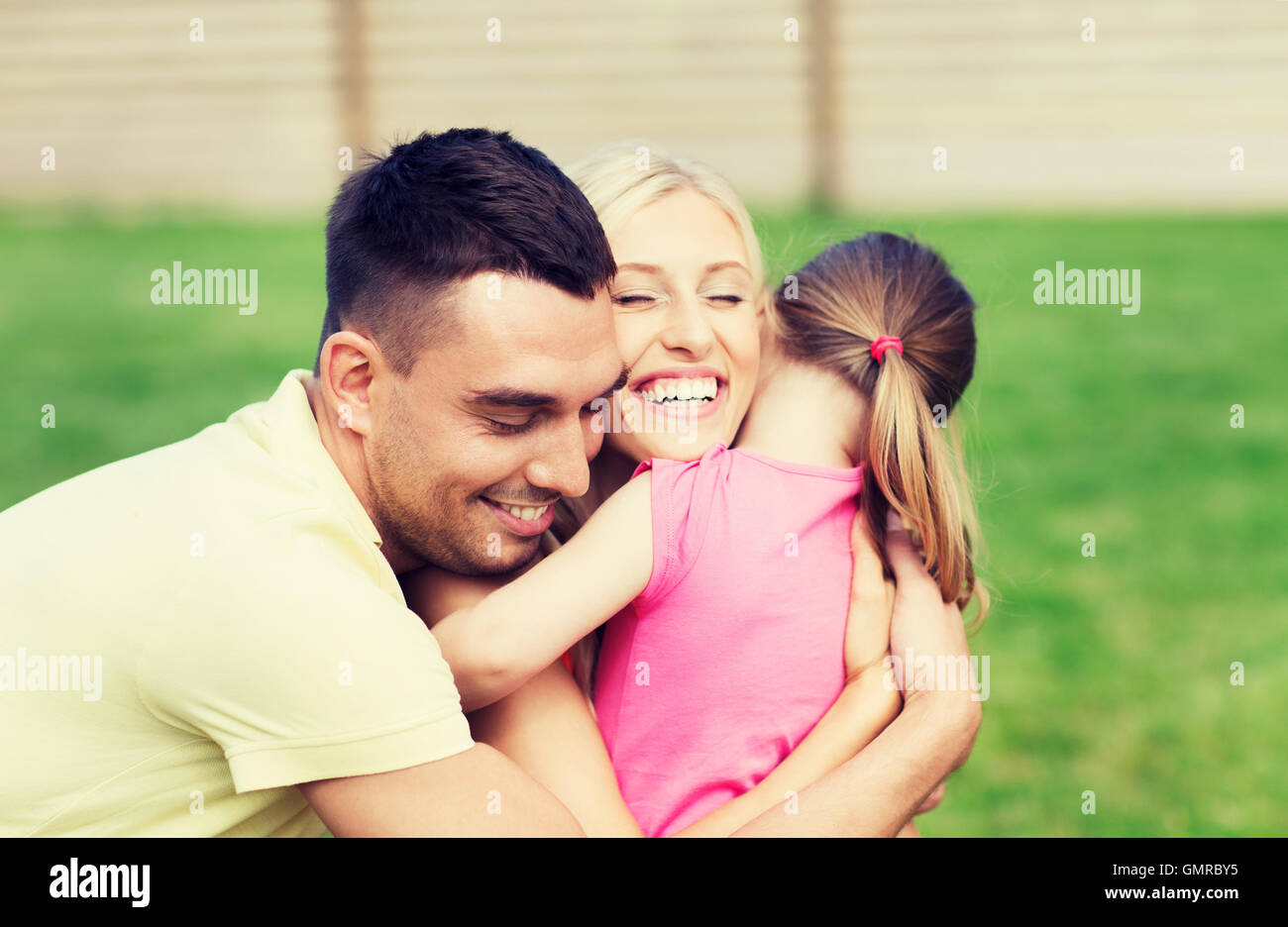 happy family hugging outdoors Stock Photo - Alamy