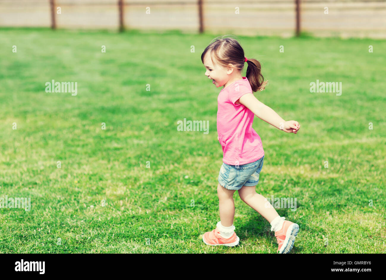 happy little girl running on green summer field Stock Photo - Alamy