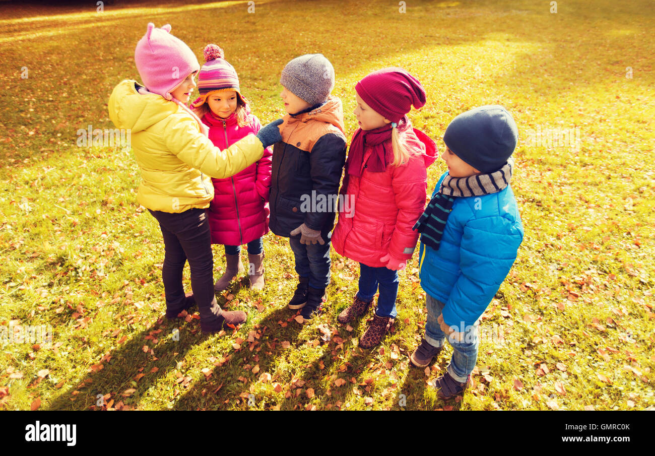 kids in autumn park counting and choosing leader Stock Photo - Alamy