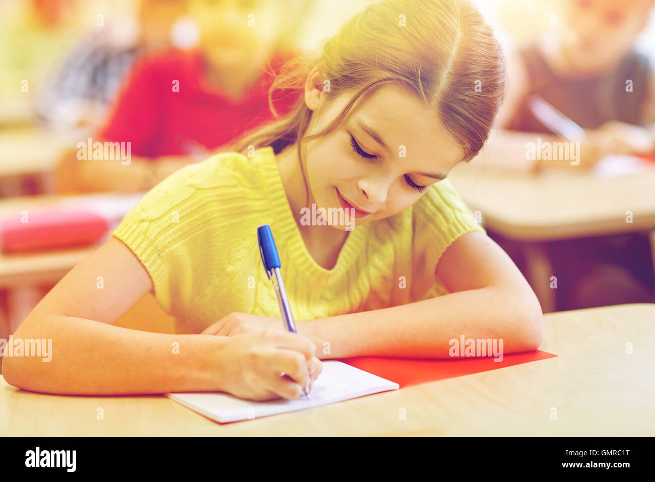 group of school kids writing test in classroom Stock Photo - Alamy