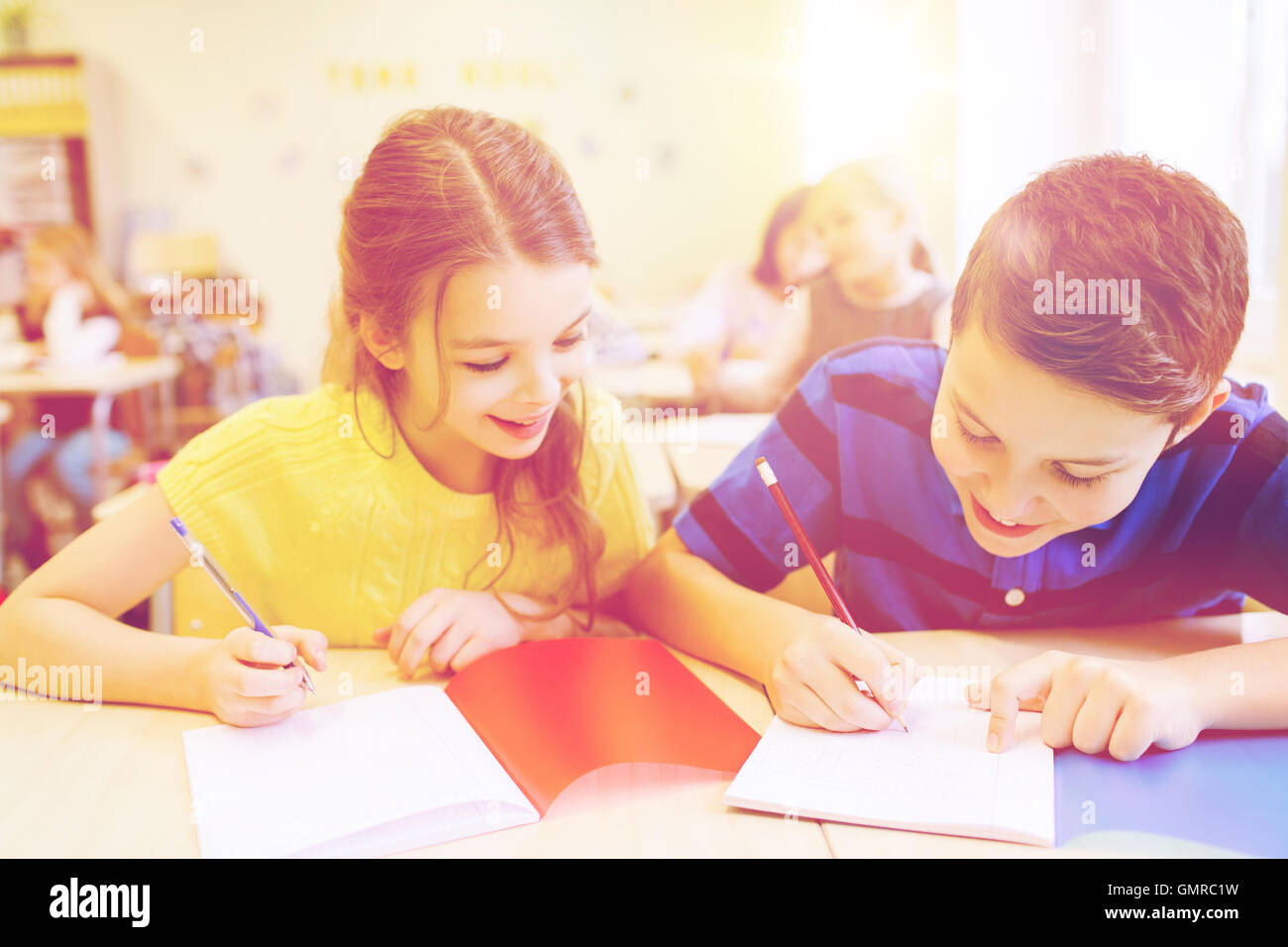 group of school kids writing test in classroom Stock Photo - Alamy