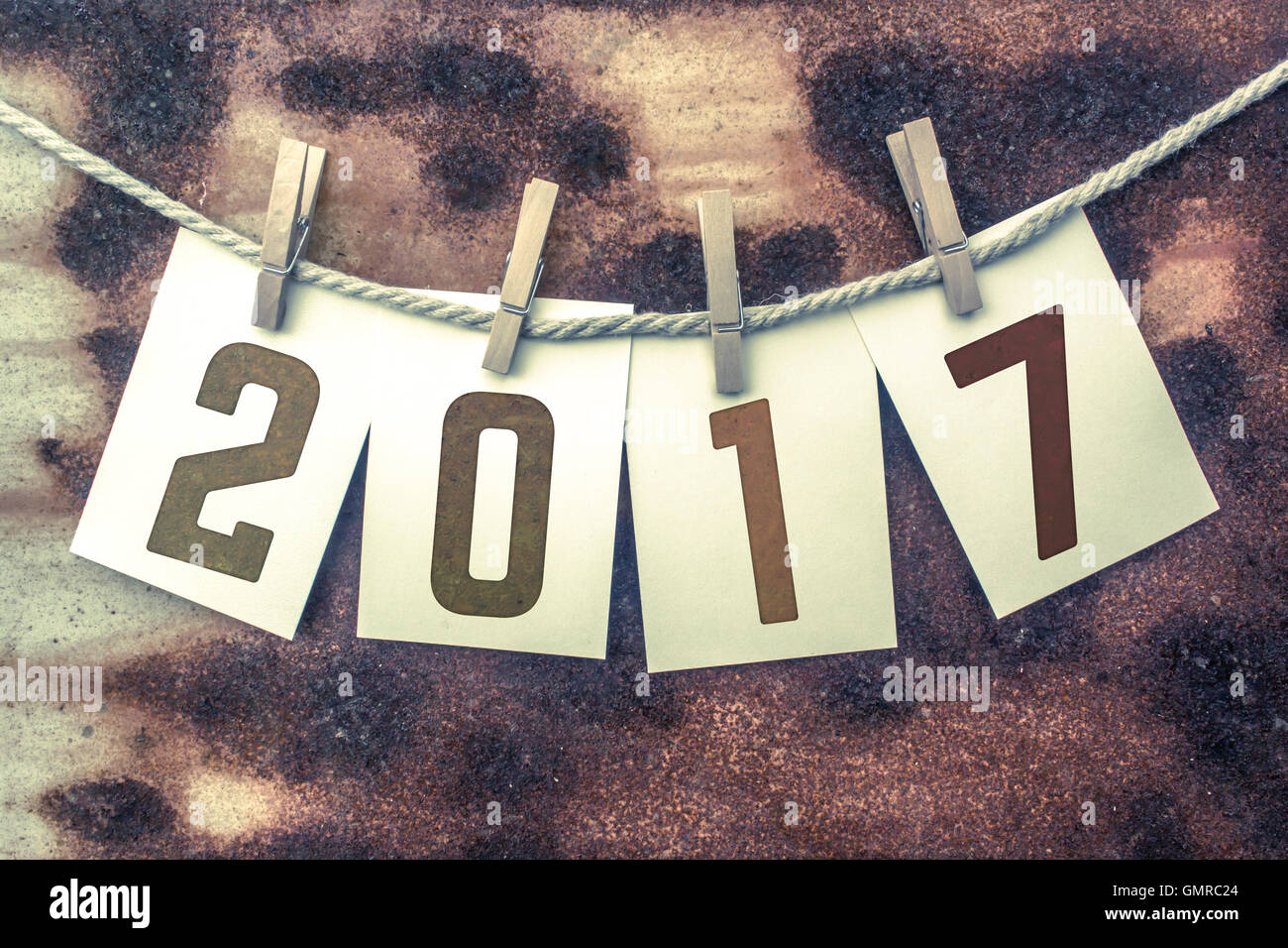 The word "2017" stamped on cards and pinned to an old piece of twine ...