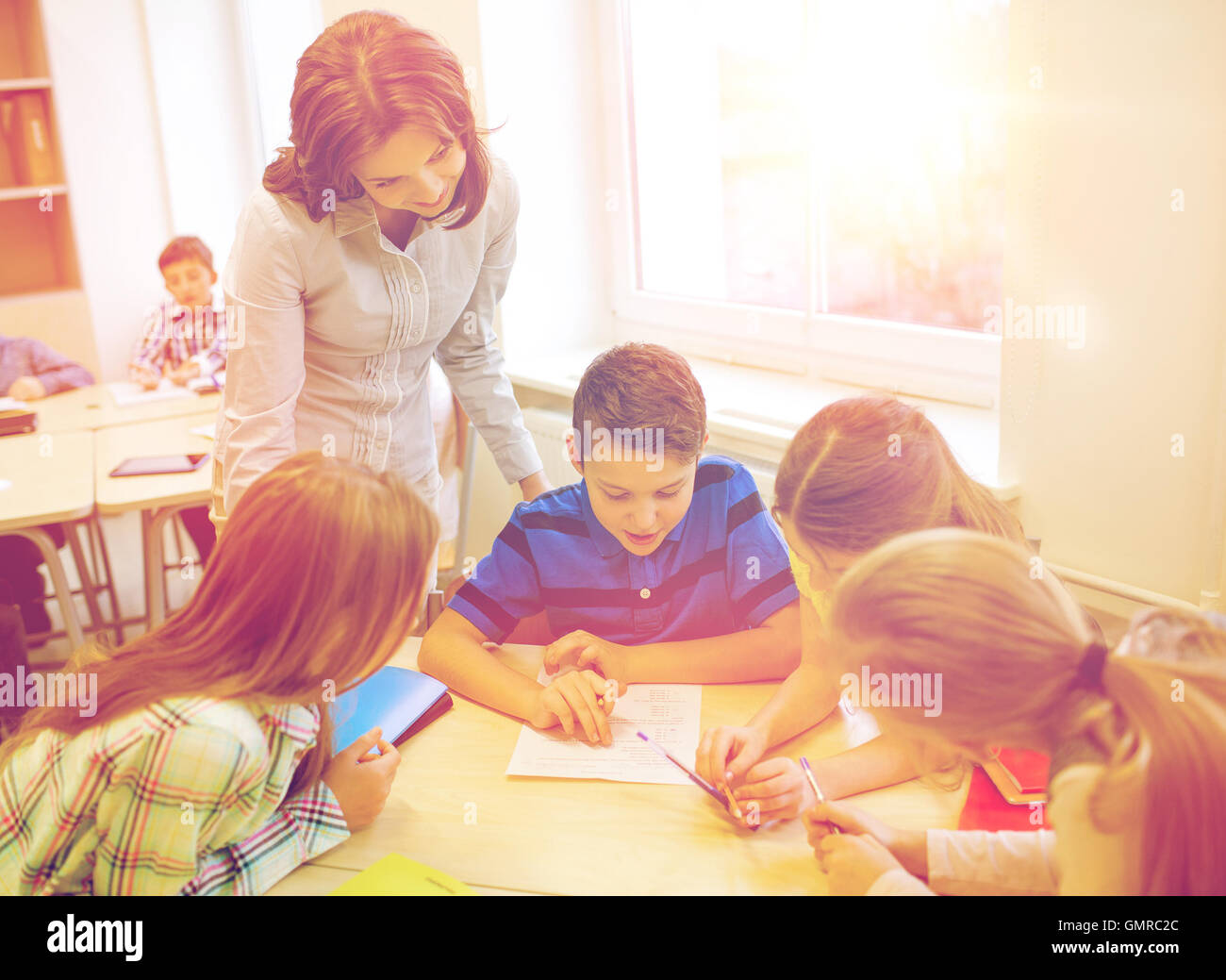 group of school kids writing test in classroom Stock Photo - Alamy