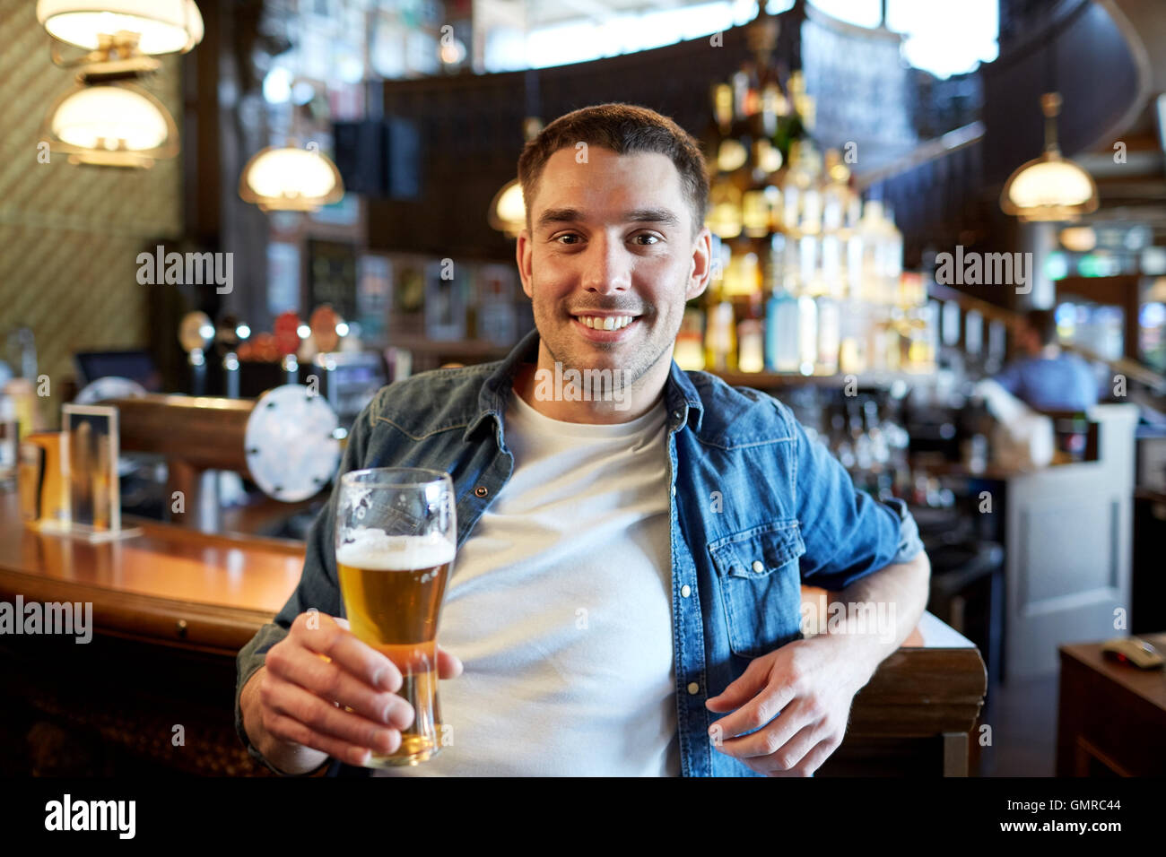 happy man drinking draft beer at bar or pub Stock Photo - Alamy