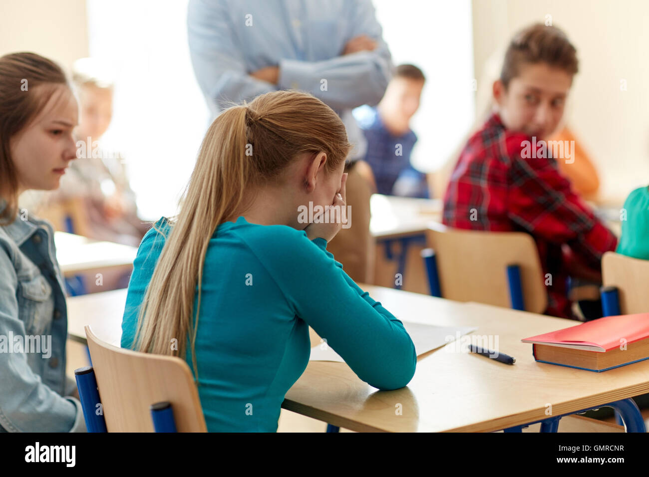 crying student girl with test result and teacher Stock Photo - Alamy