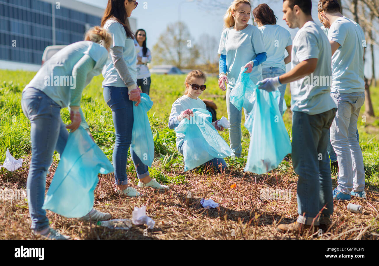 volunteers with garbage bags cleaning park area Stock Photo - Alamy
