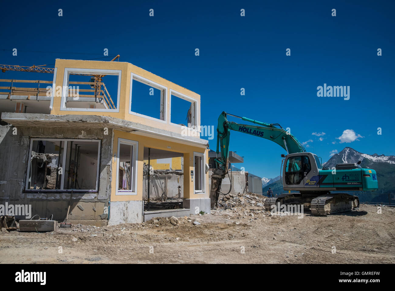 Building construction in progress with demolition of an old building ...