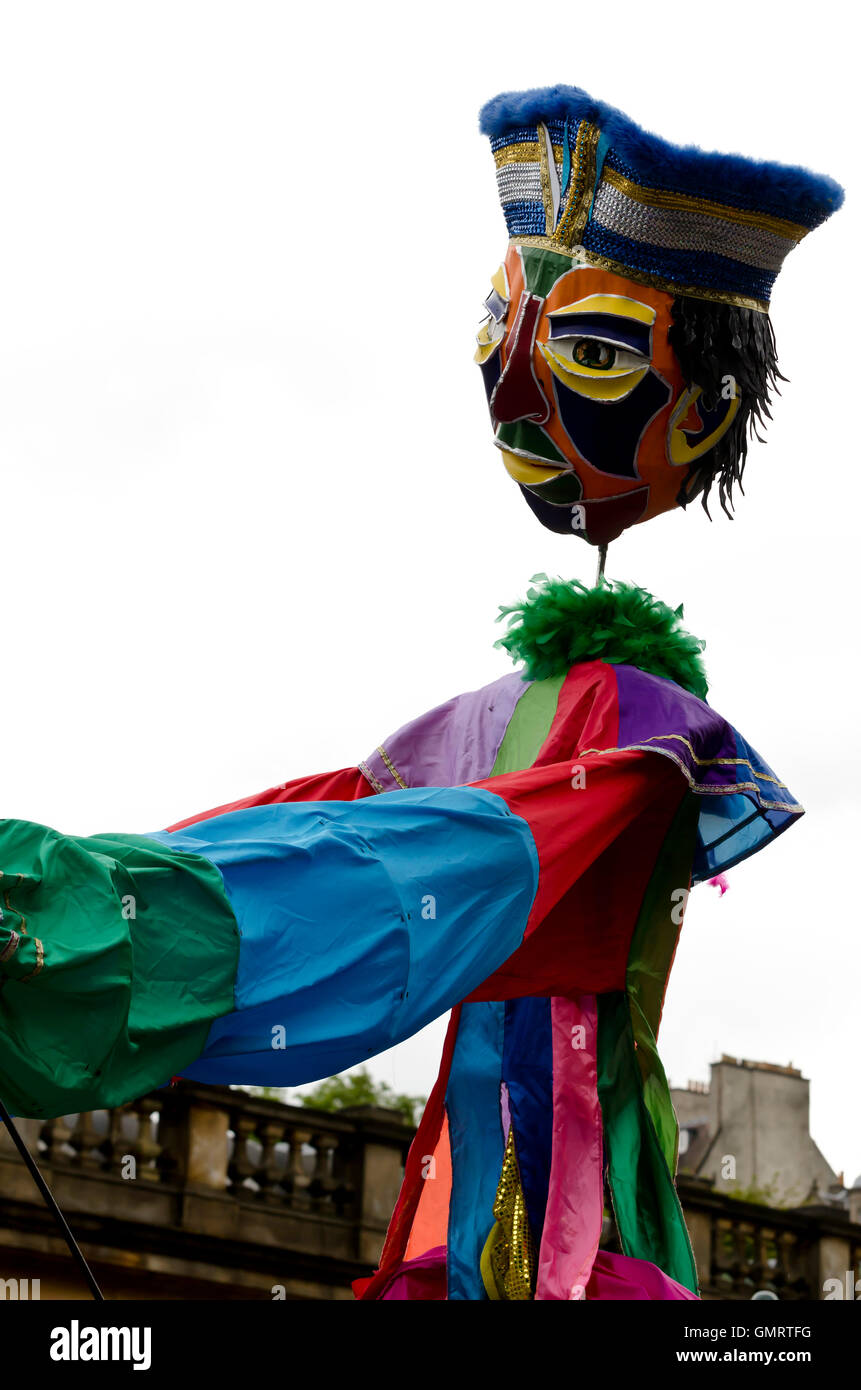 A tall, colourful puppet character taking part in the Cavalcade, part ...