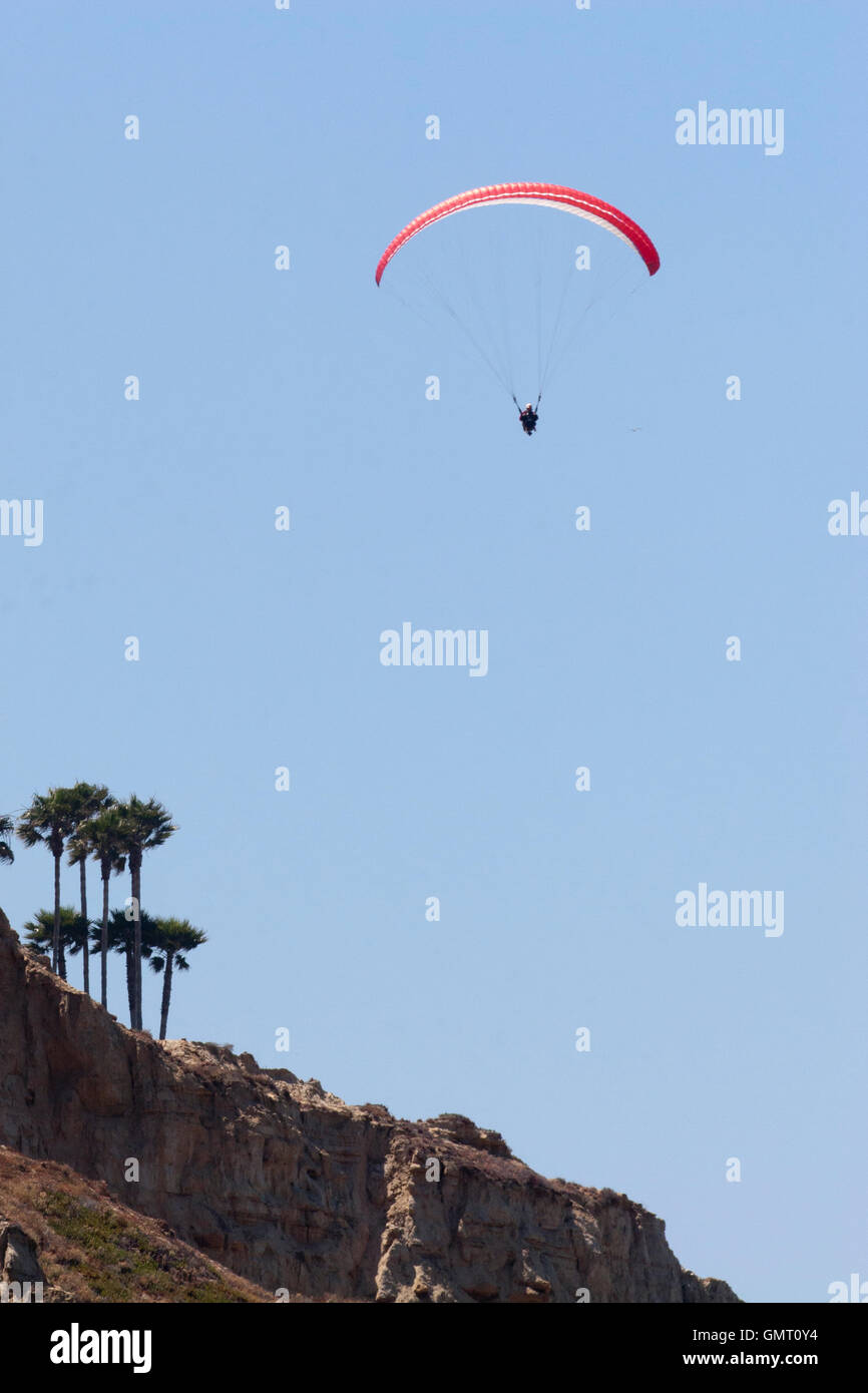 Person paragliding over cliffs in San Diego, California Stock Photo - Alamy