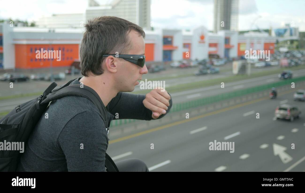 Outdoor portrait of modern young man with smart watch in the street ...