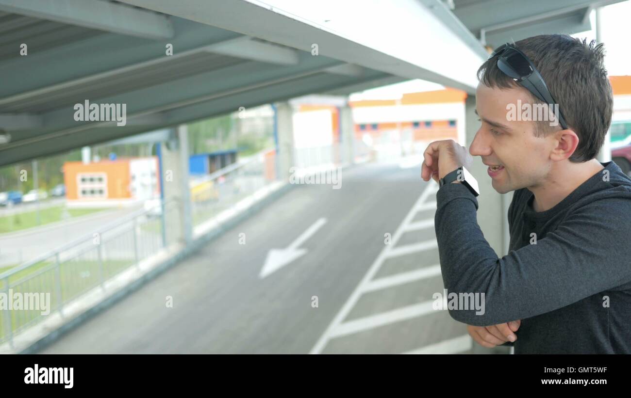 Outdoor portrait of modern young man with smart watch in the street ...