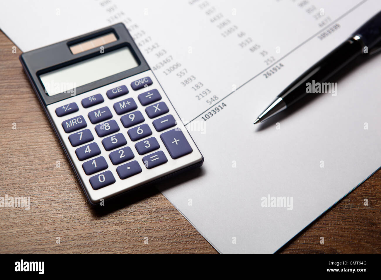 work on the calculator and papers Stock Photo - Alamy
