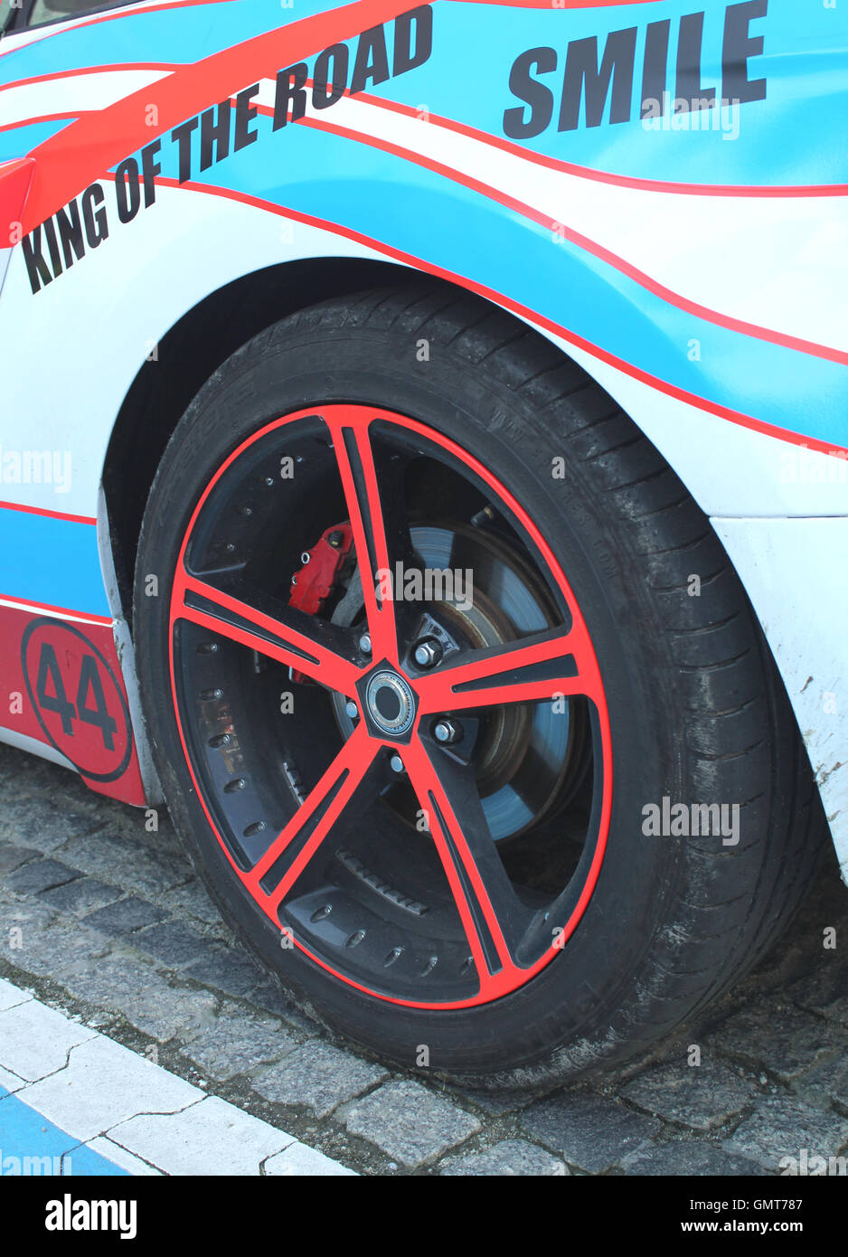 Close up of a car wheel with red brake Stock Photo - Alamy