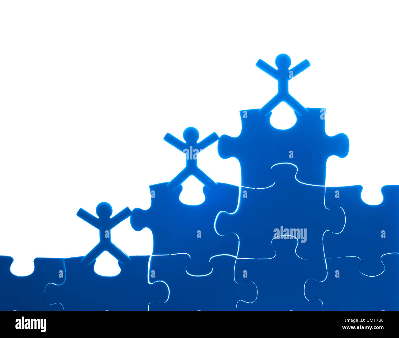 Team work on solving puzzle problem Stock Photo - Alamy
