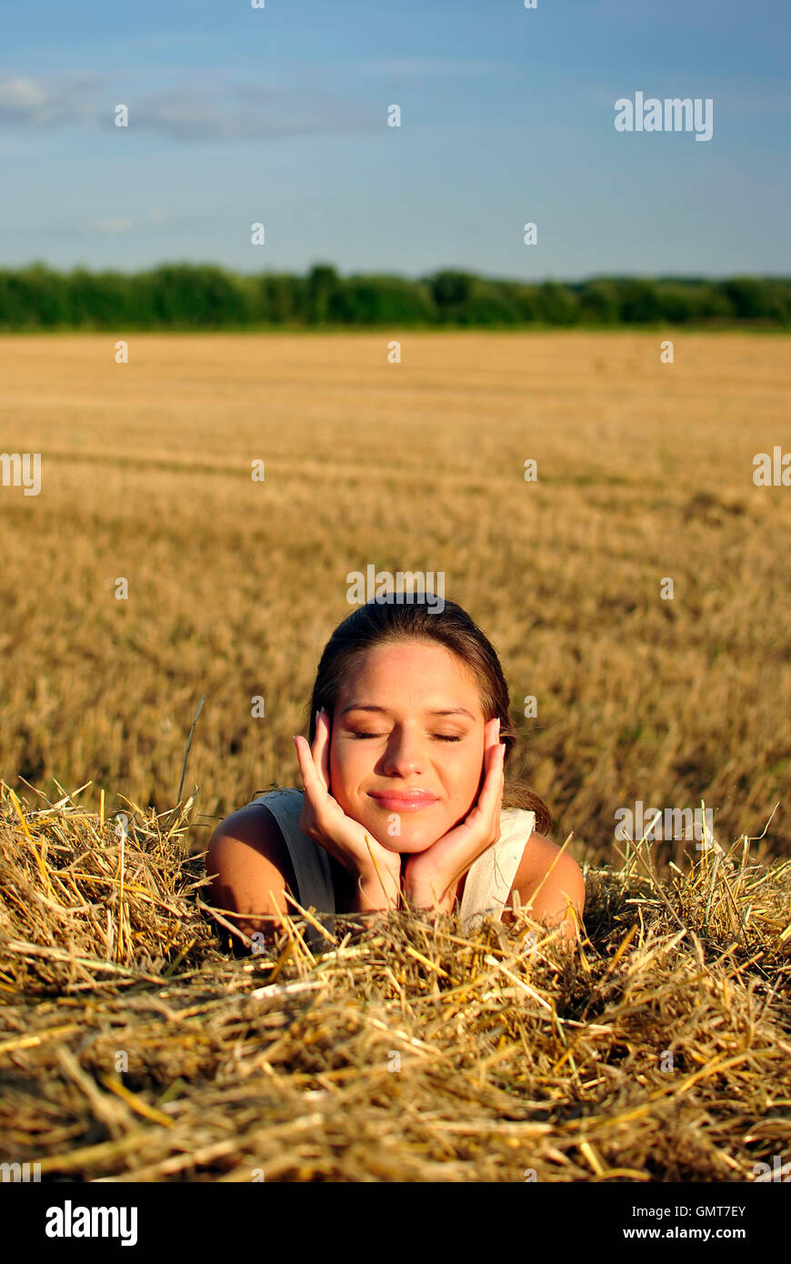 girl in traditional Russian costume resting on a haystack Stock Photo ...
