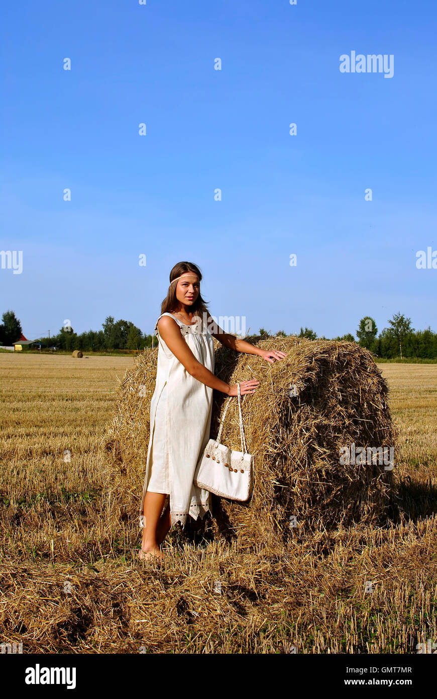 girl in a rural clothing standing near haystack Stock Photo - Alamy