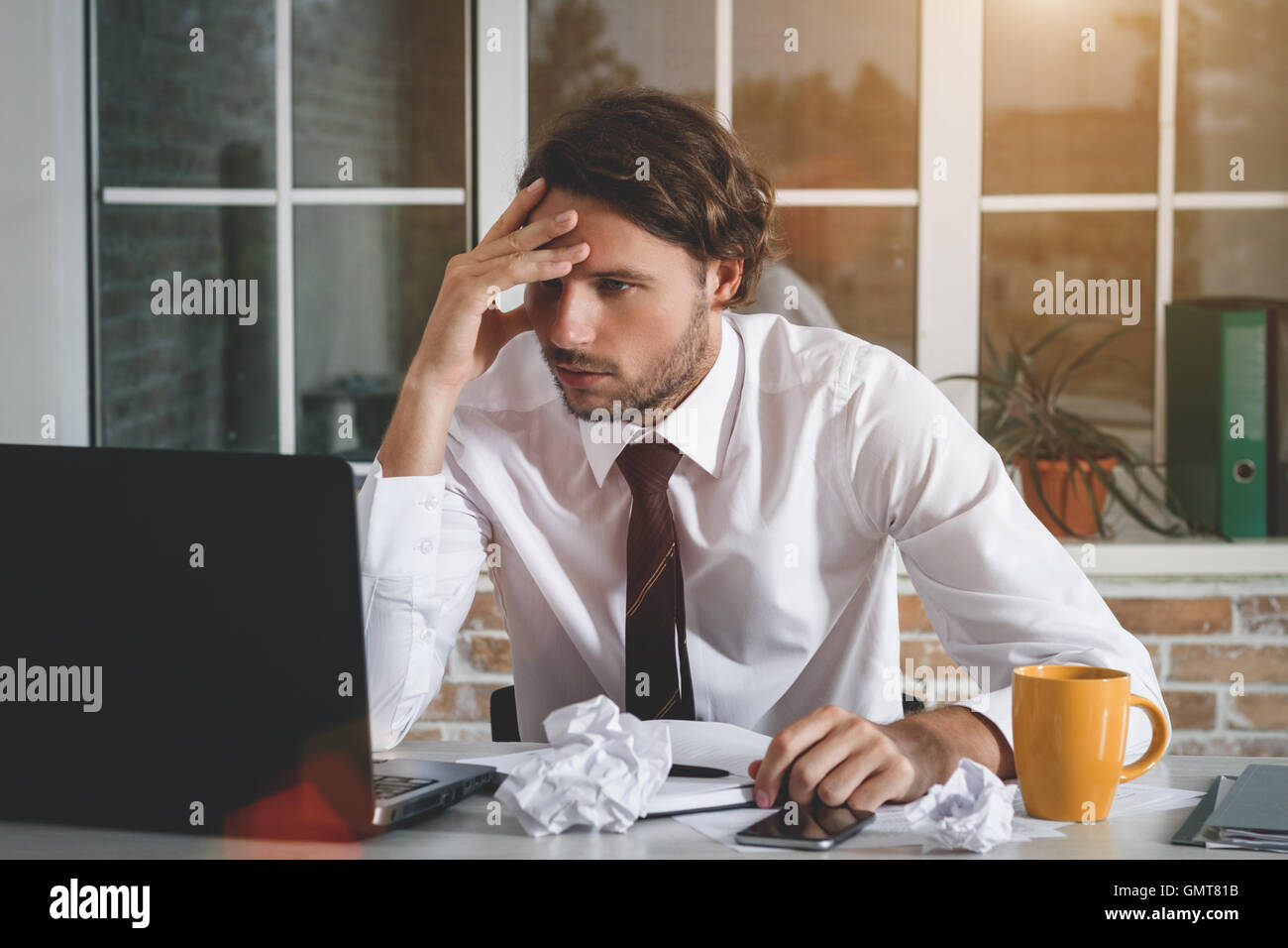 Sad businessman using laptop hi-res stock photography and images - Alamy