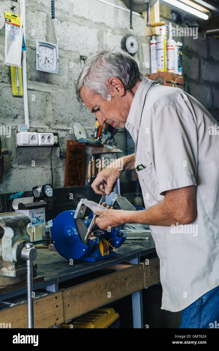 Close-up of workman working with iron Stock Photo - Alamy