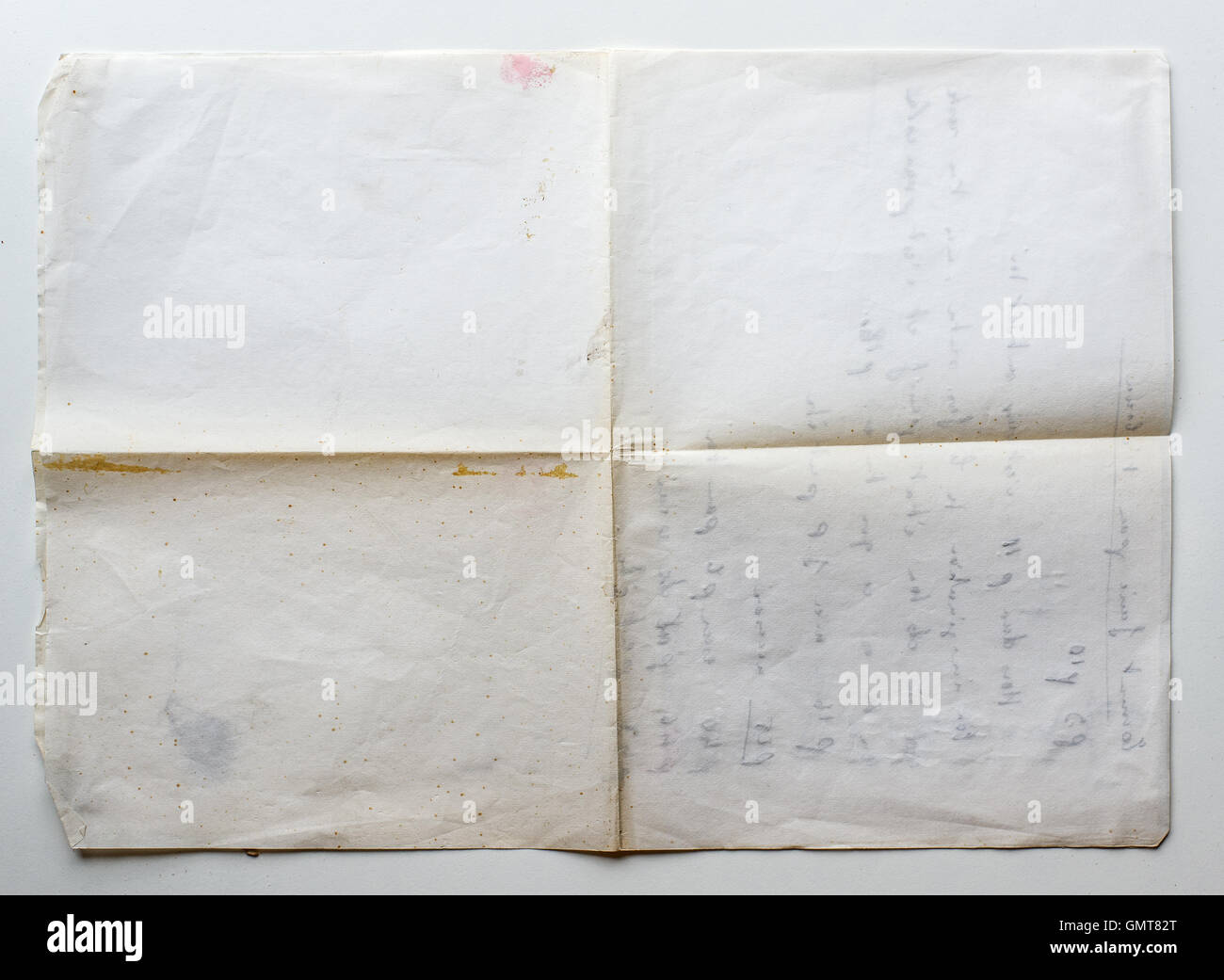 Old grunge paper on white background with handwriting on the reverse ...