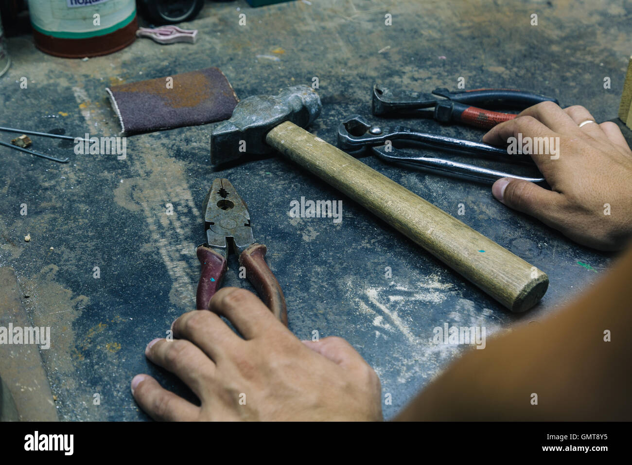 male hands near tools on iron table Stock Photo - Alamy
