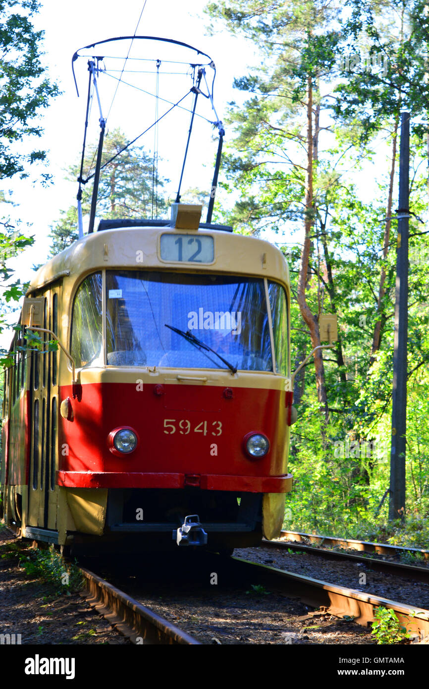Retro red tram car rides on the same railway the woods Stock Photo - Alamy