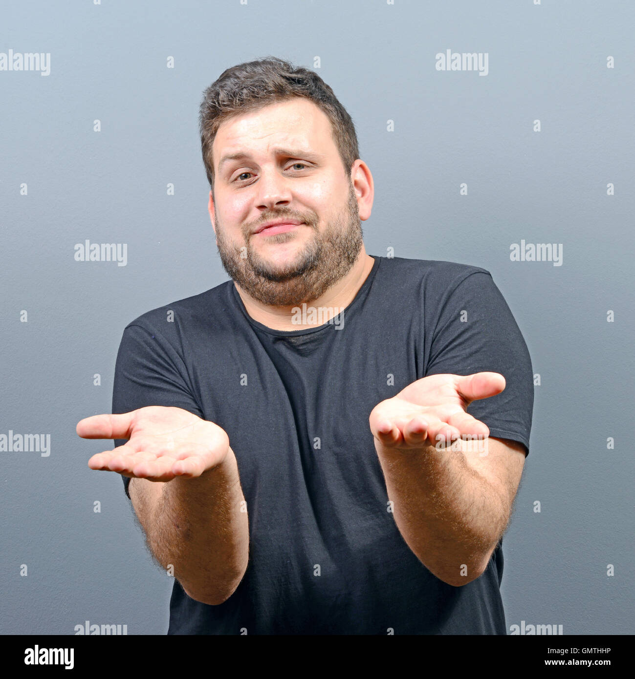 Portrait of a confused man against gray background Stock Photo - Alamy