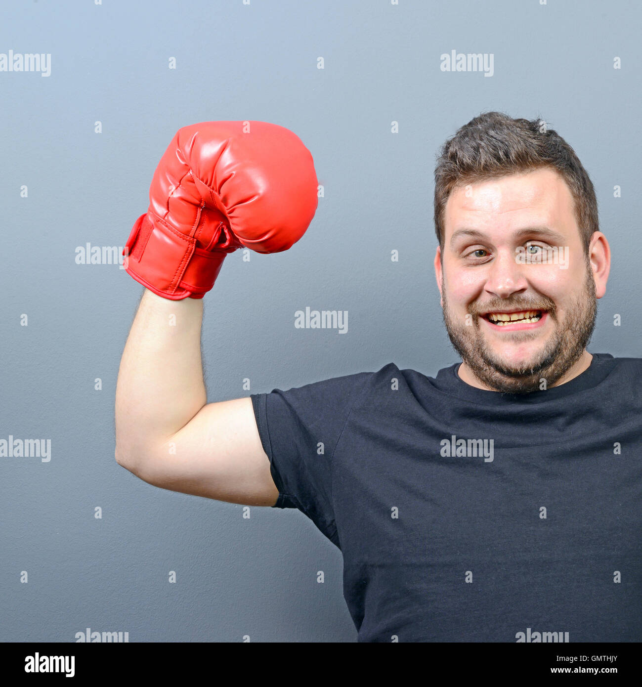 Portrait of chubby boxer posing with boxing gloves as a champion Stock ...