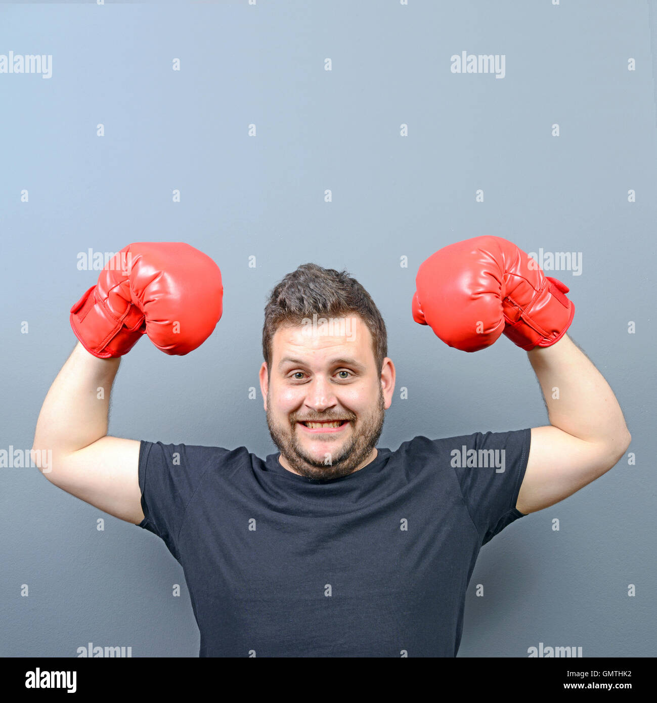 Portrait of chubby boxer posing with boxing gloves as a champion Stock ...
