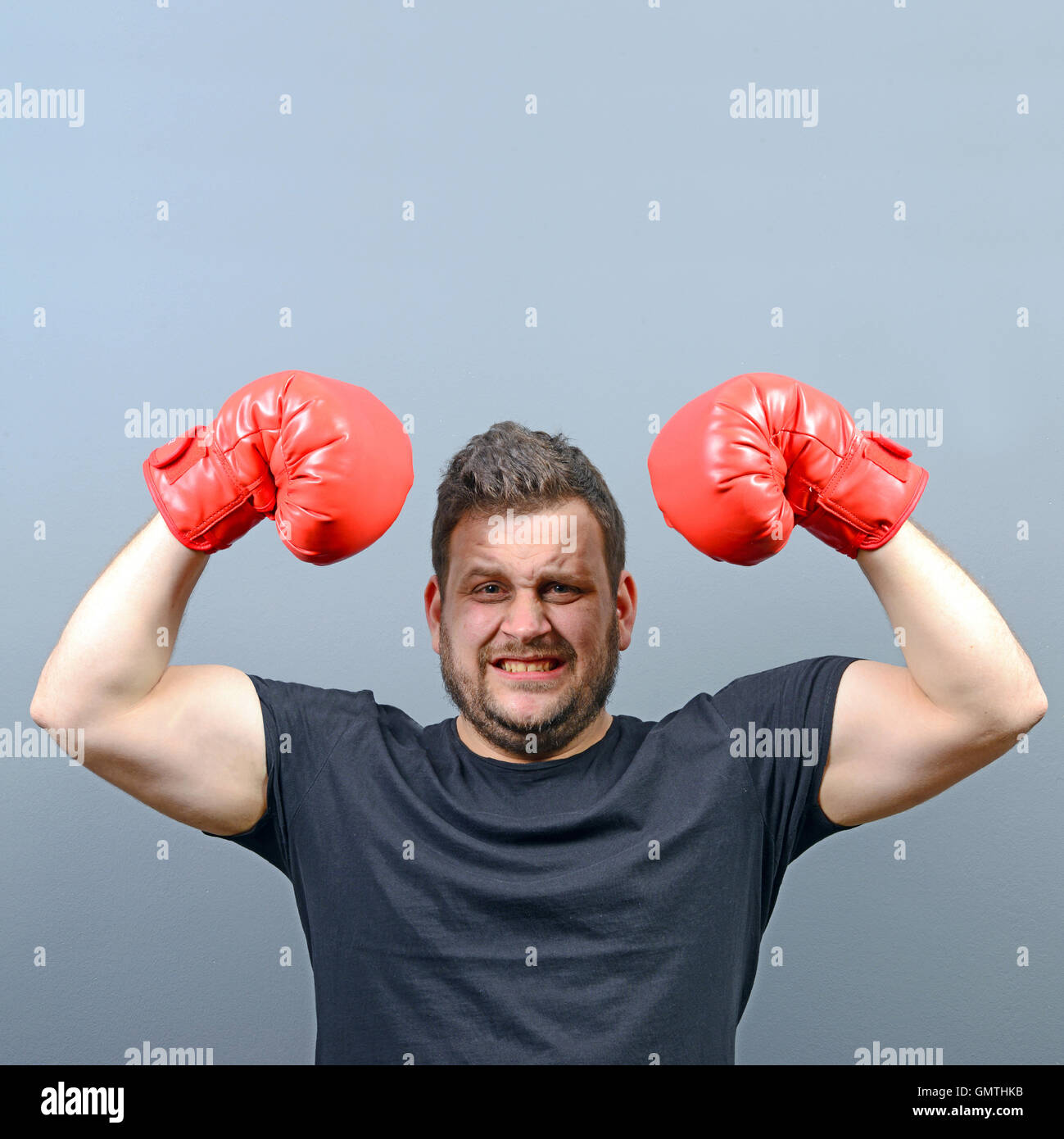 Portrait of chubby boxer posing with boxing gloves as a champion Stock ...