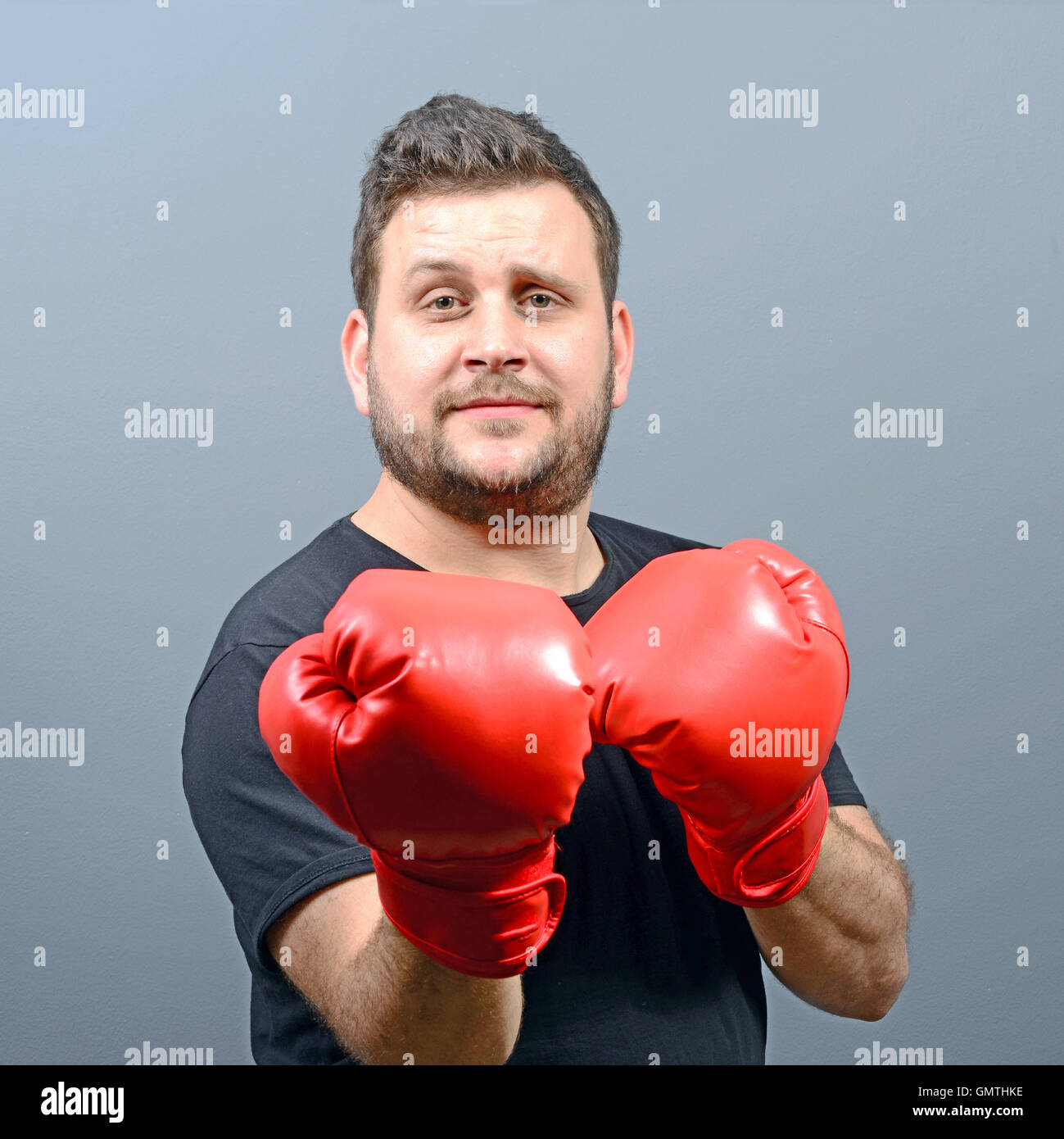 Portrait of chubby boxer posing with boxing gloves Stock Photo - Alamy