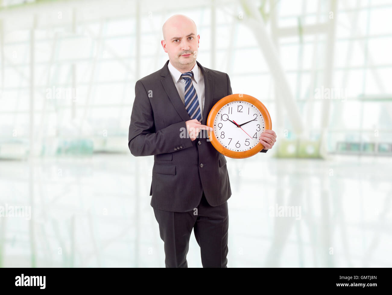 mad businessman with clock at the office Stock Photo - Alamy