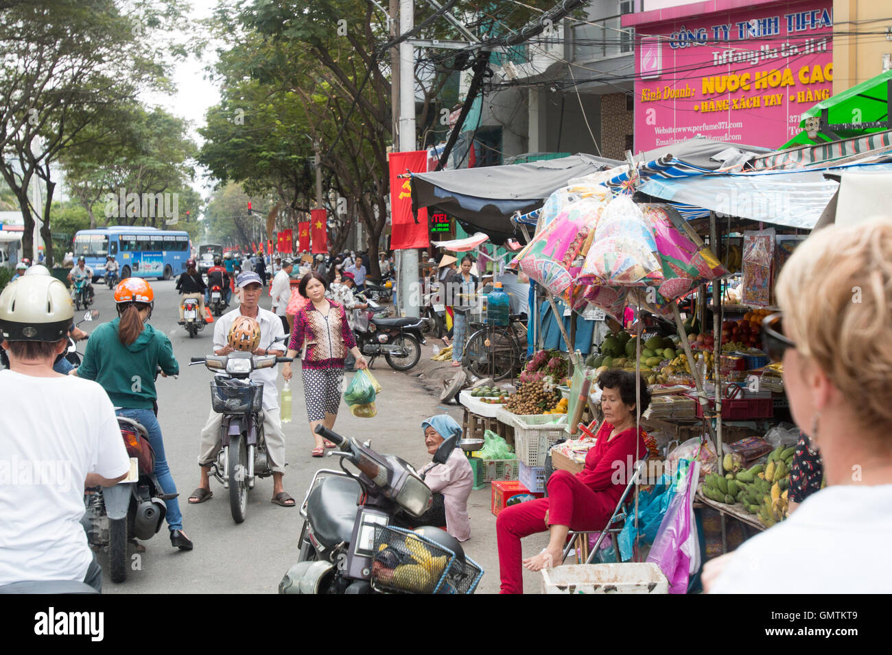 typical urban street scene with market stalls in Ho Chi Minh city ...