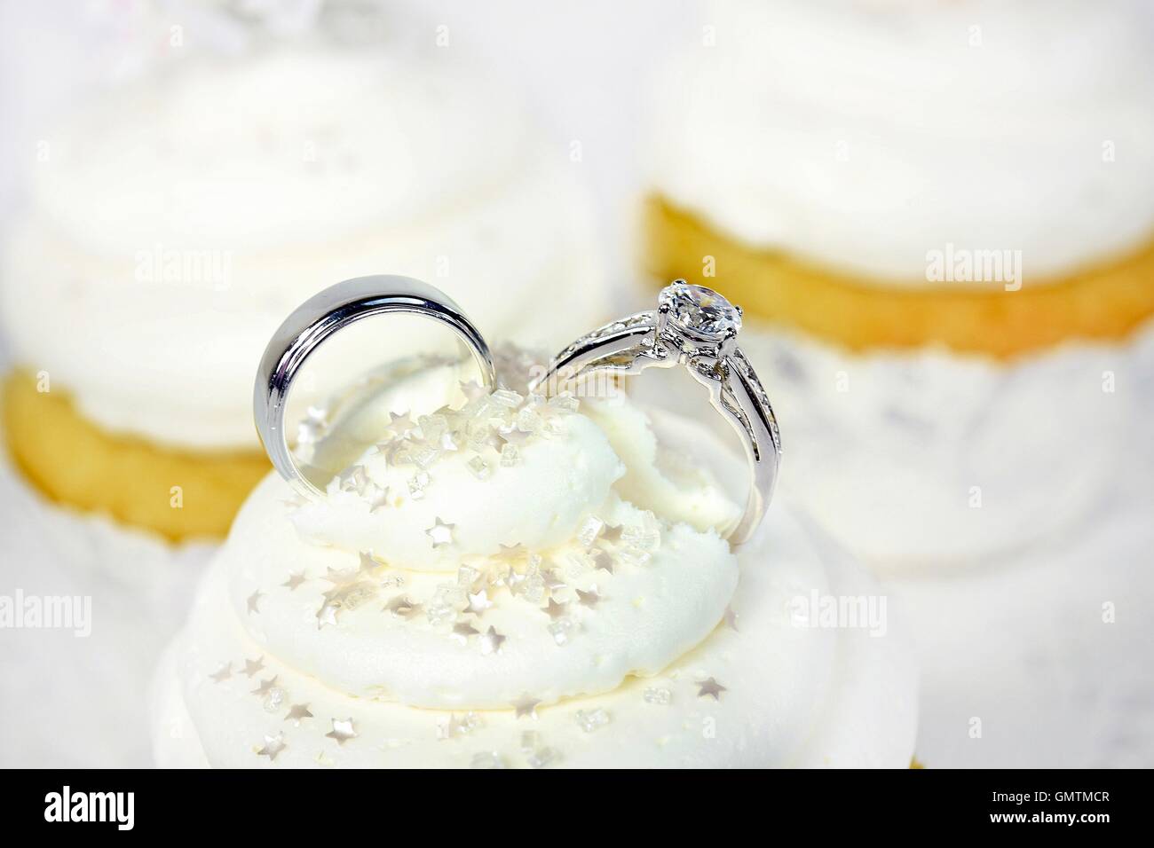 wedding rings in cupcake icing with star sprinkles Stock Photo - Alamy