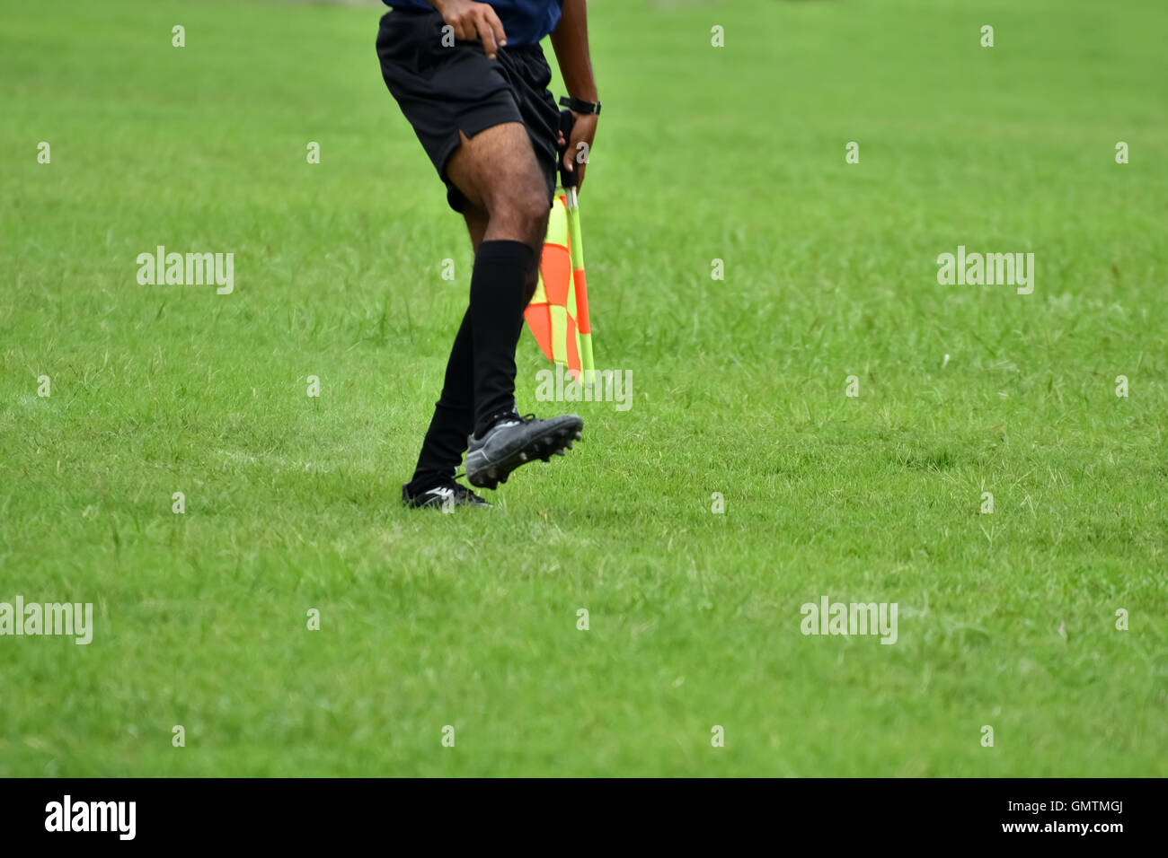 Assistant referee running along the sideline Stock Photo - Alamy