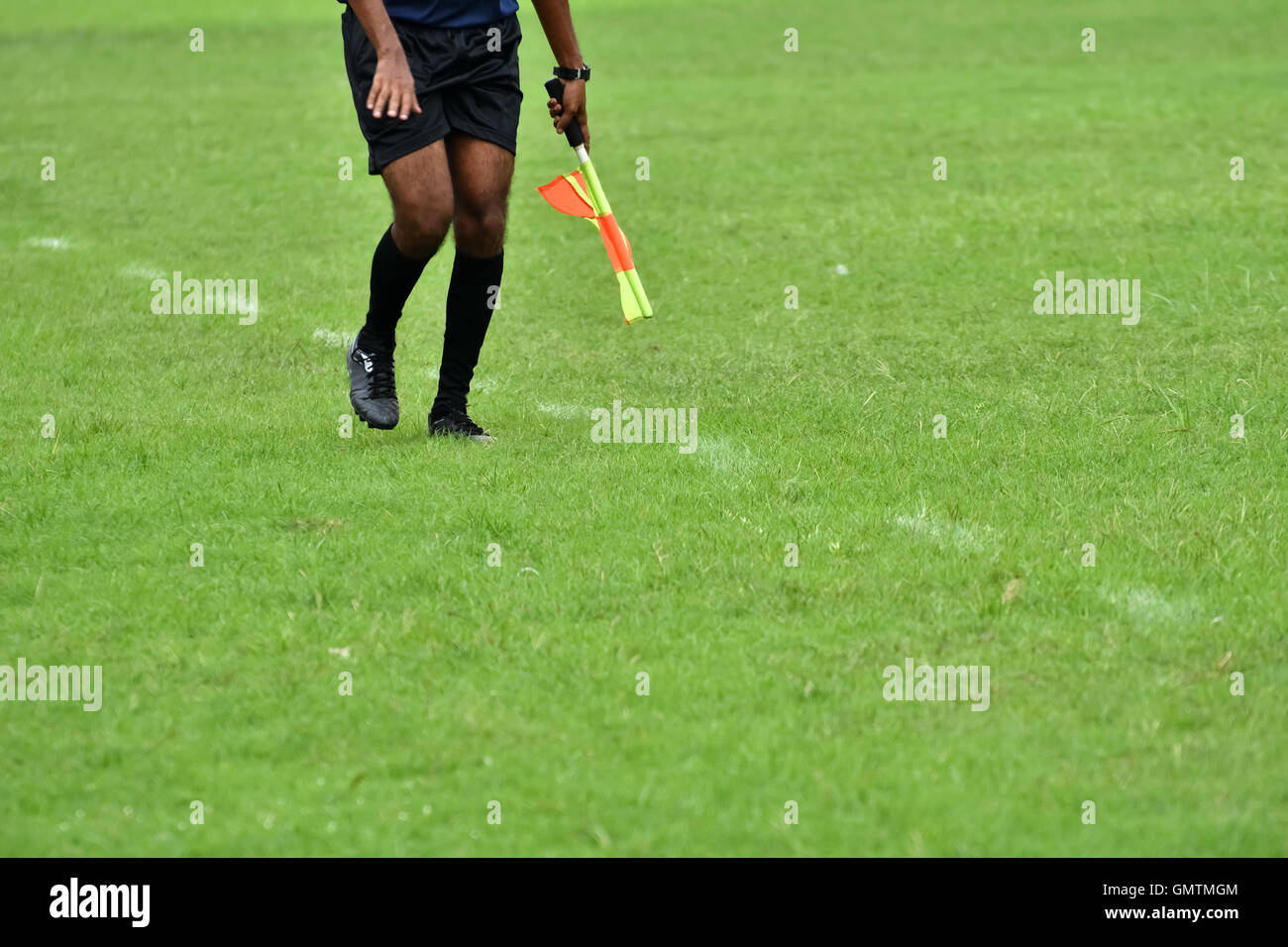 Assistant referee running along the sideline Stock Photo - Alamy