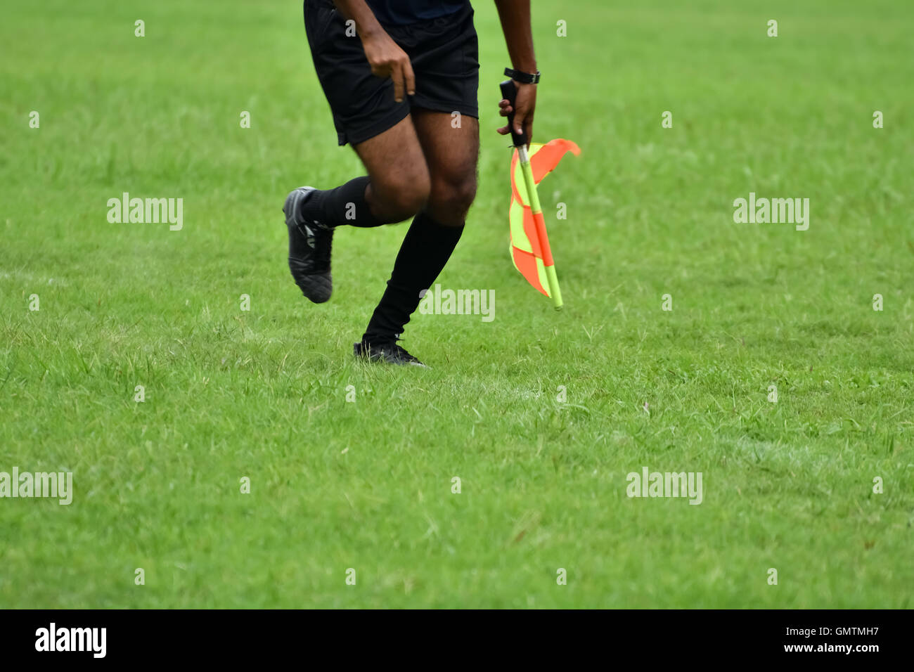 Assistant referee running along the sideline Stock Photo - Alamy